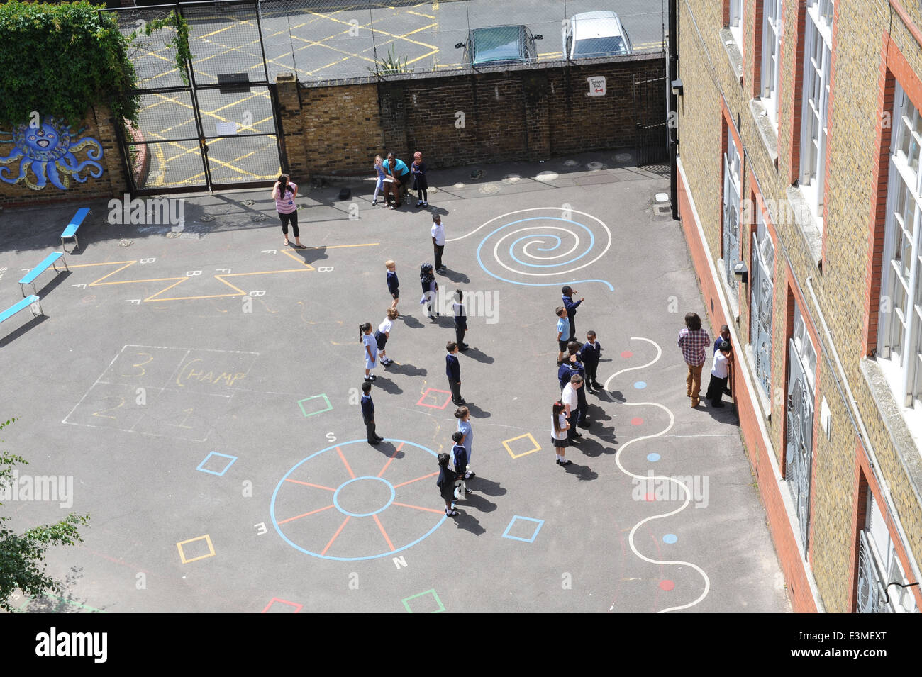 School children playing in a school playground in an inner city london ...