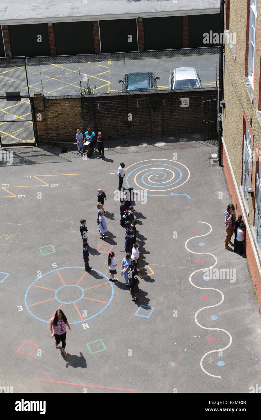 School children playing in a school playground in an inner city london ...