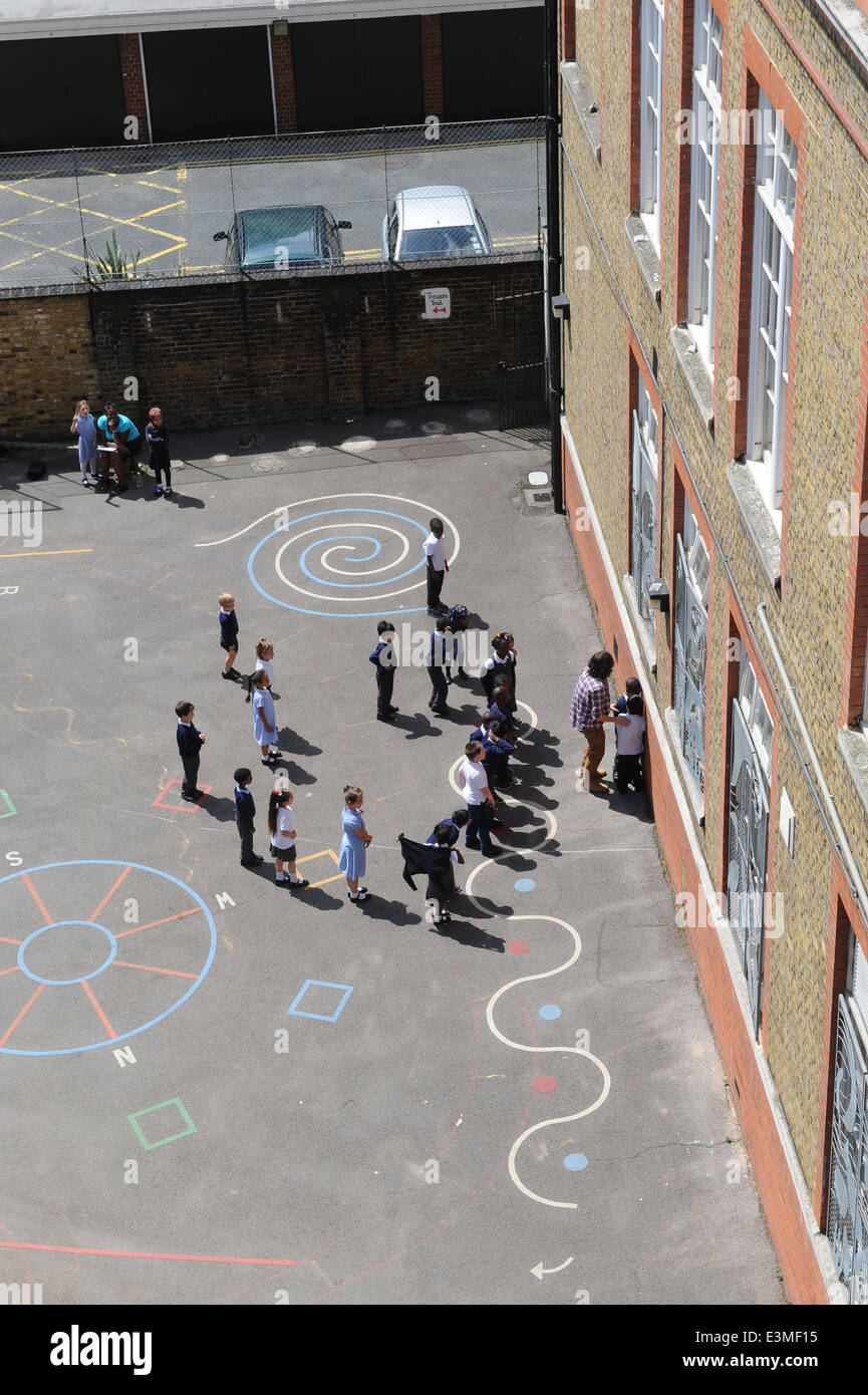 School children playing in a school playground in an inner city london ...