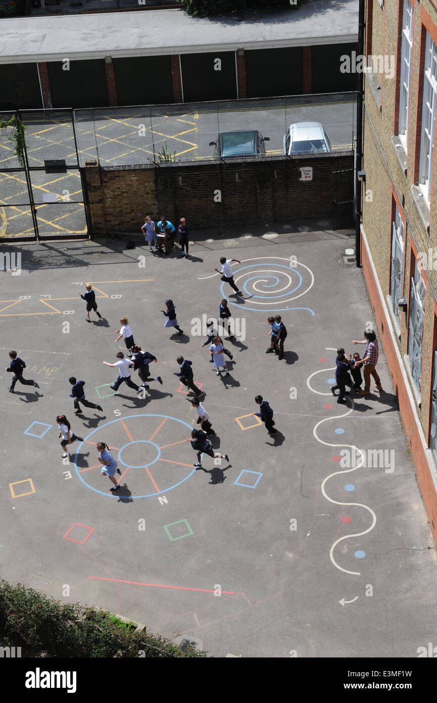 School children playing in a school playground in an inner city london ...