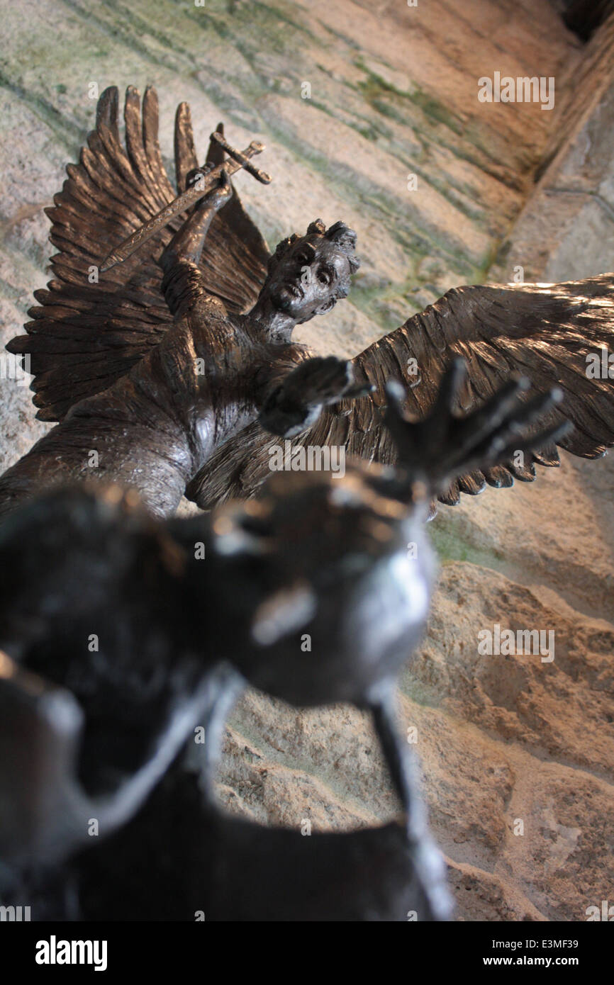 Statue of an angel battling a demon Stock Photo - Alamy