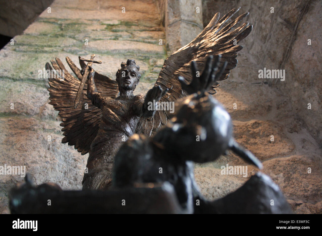 Statue of an angel battling a demon Stock Photo - Alamy