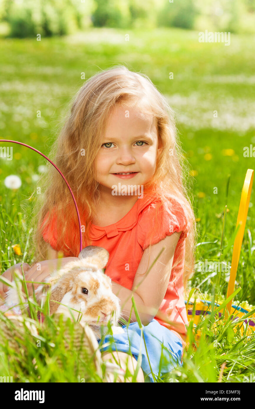 Little girl with rabbit in the basket Stock Photo - Alamy