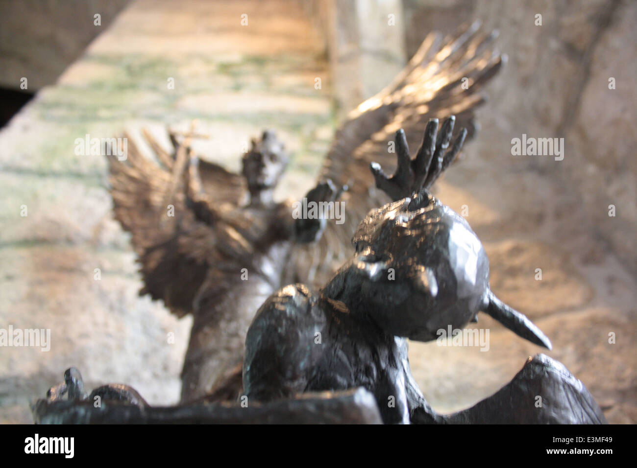 Statue of an angel battling a demon Stock Photo - Alamy