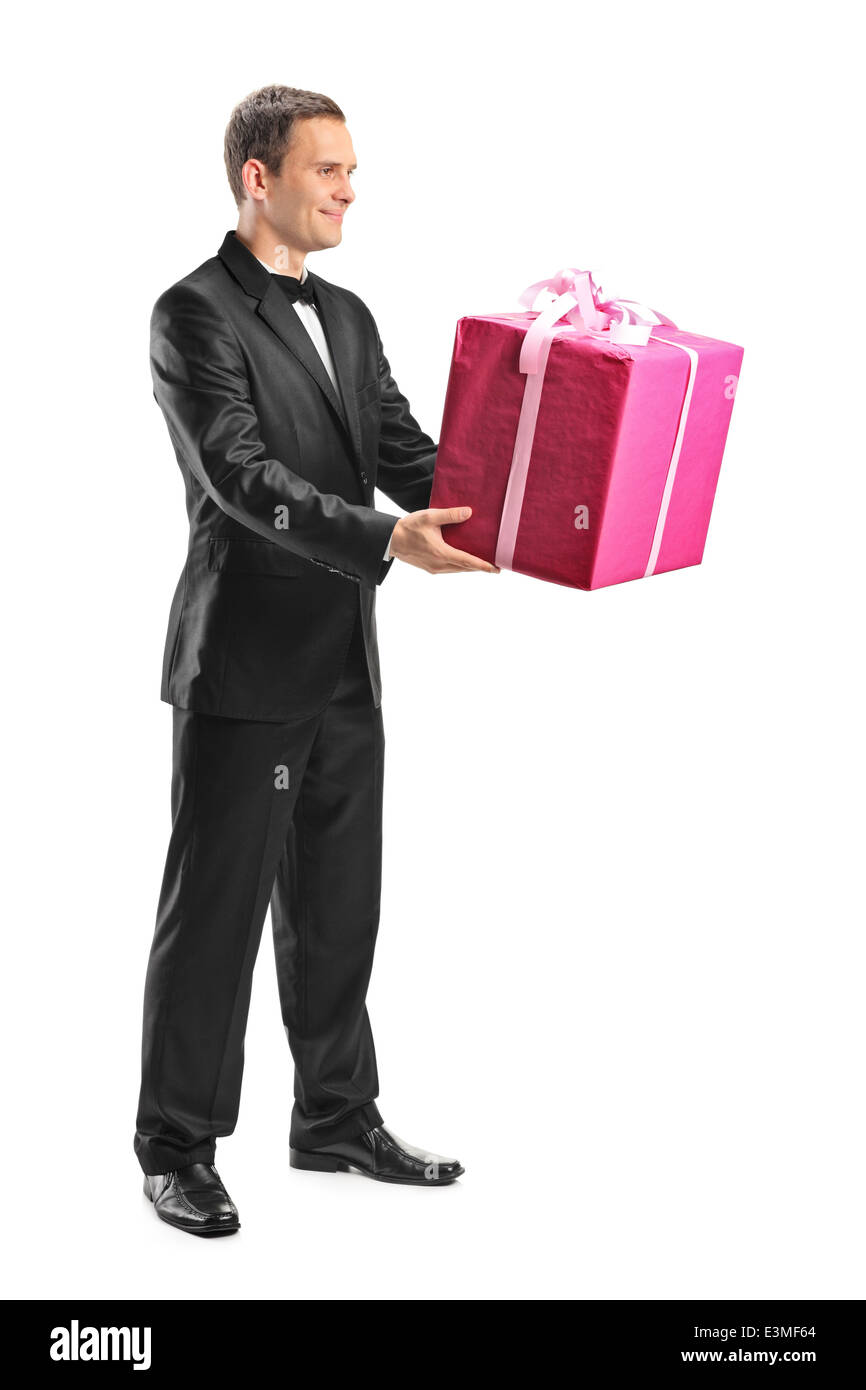 Full length portrait of a handsome young man holding a big present ...