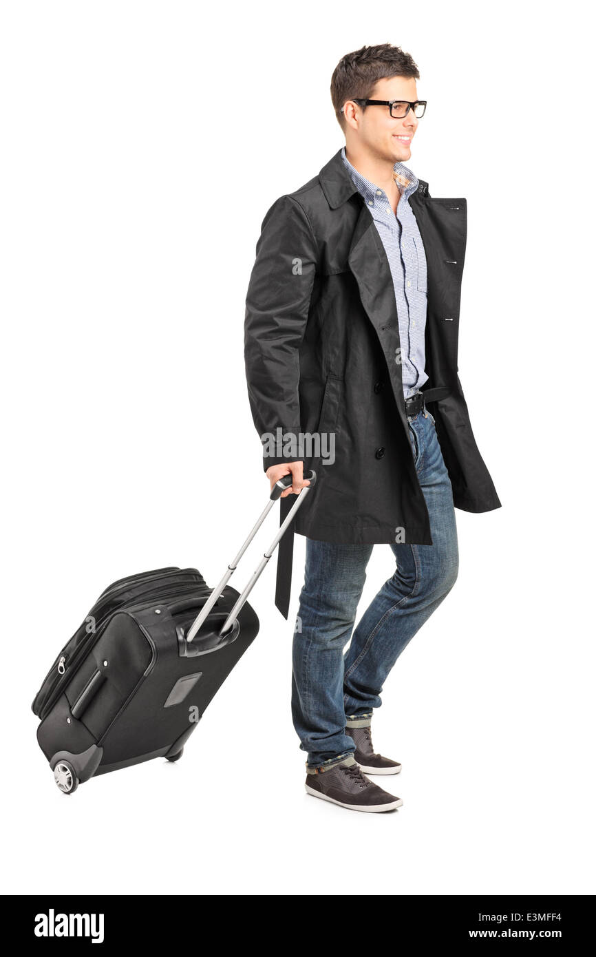 Handsome young man carrying his luggage Stock Photo - Alamy