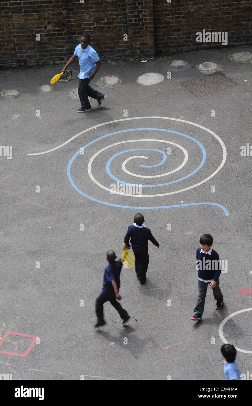 School children playing in a school playground in an inner city london ...