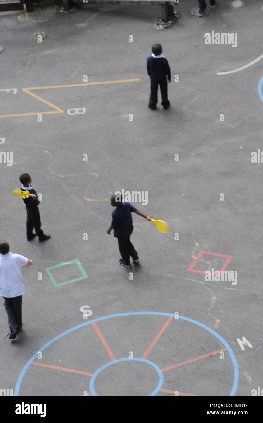 School children playing in a school playground in an inner city london ...