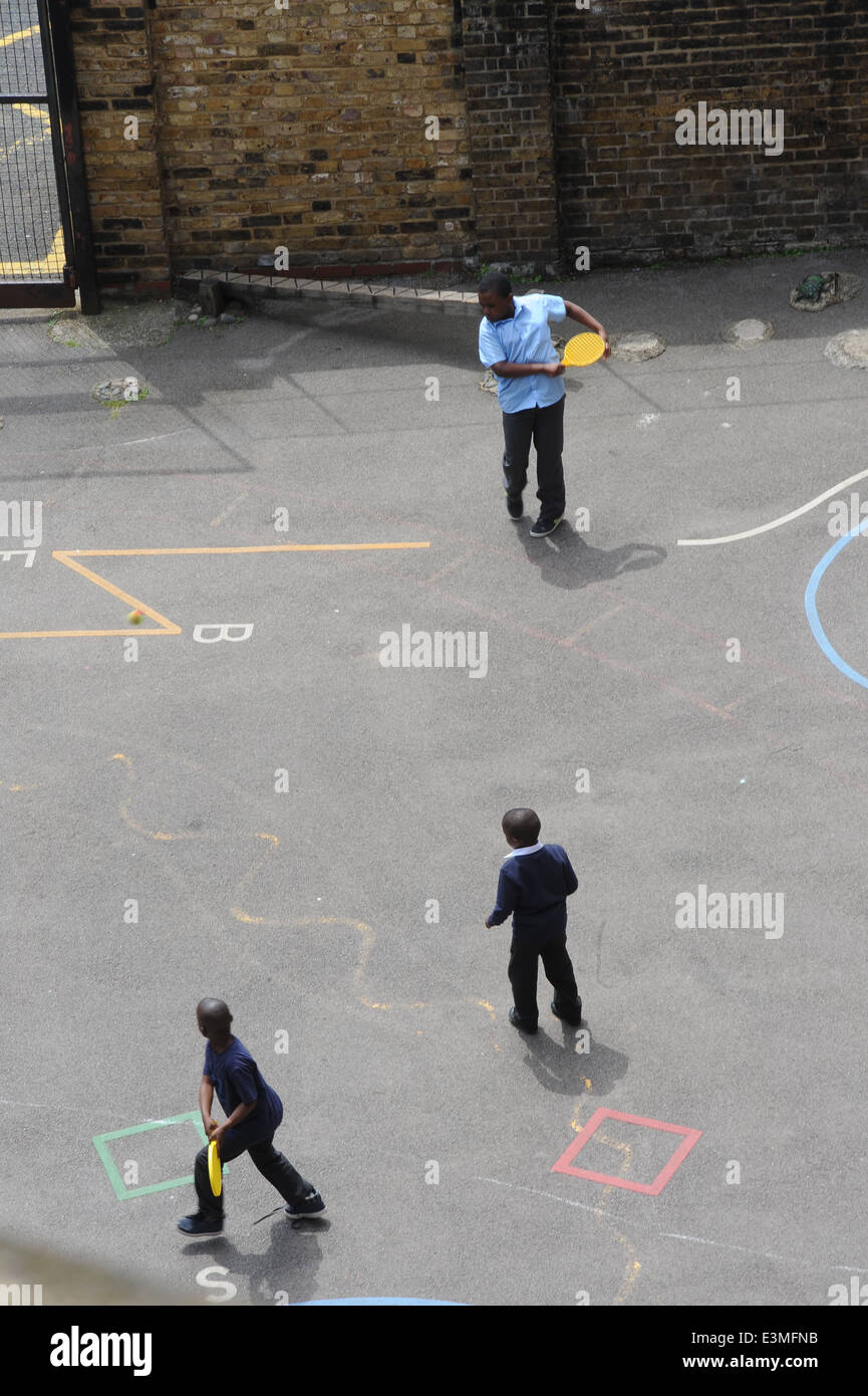 School children playing in a school playground in an inner city london ...