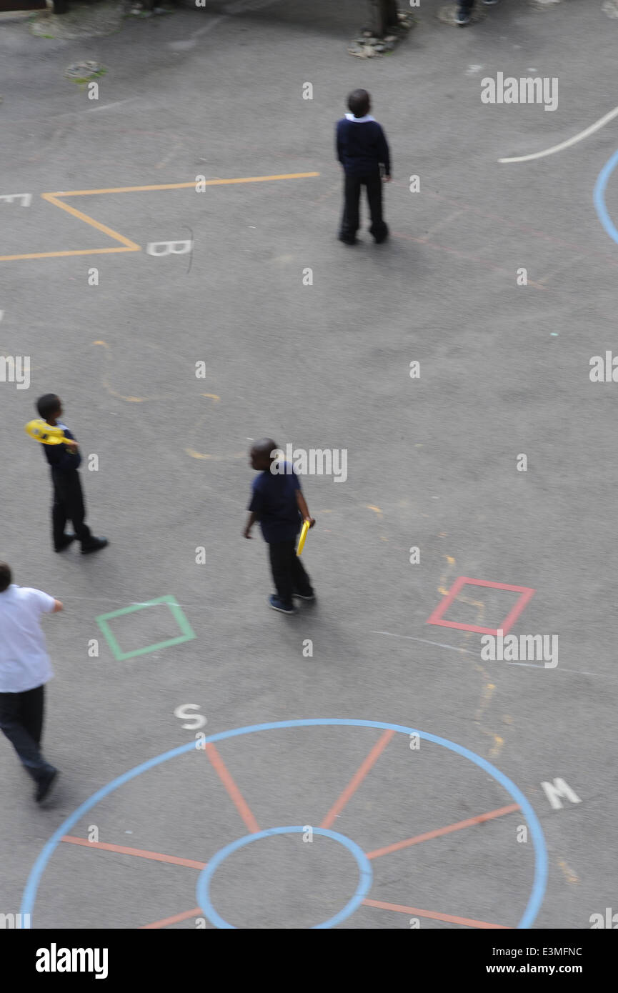 School children playing in a school playground in an inner city london ...