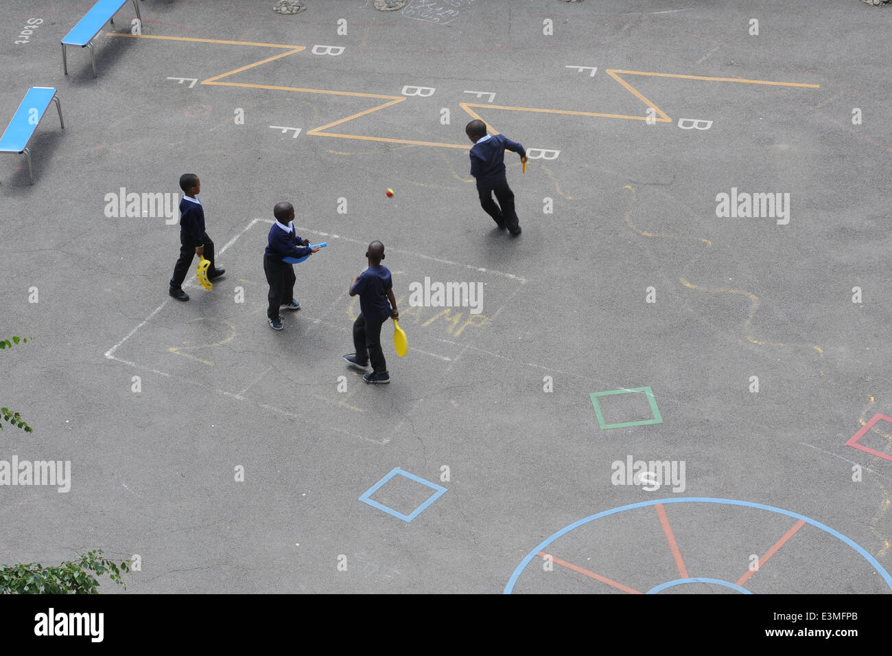 School children playing in a school playground in an inner city london ...