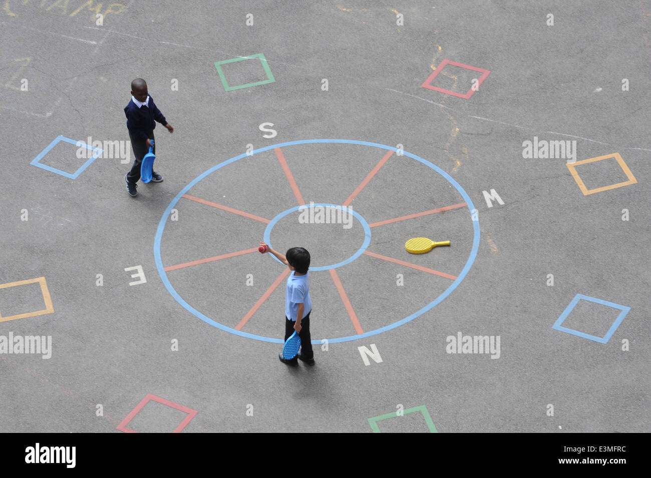 School children playing in a school playground in an inner city london ...