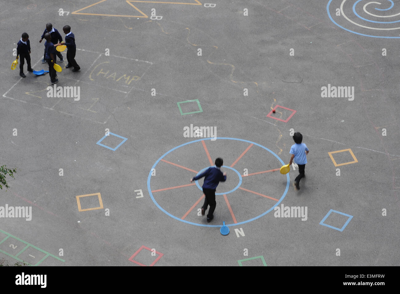 School children playing in a school playground in an inner city london ...