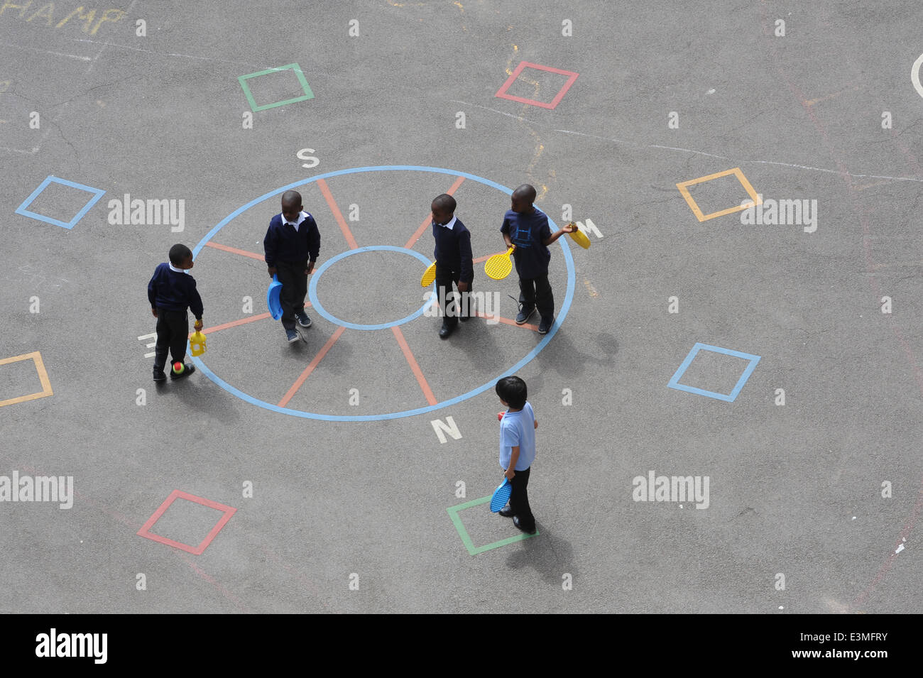 School children playing in a school playground in an inner city london ...