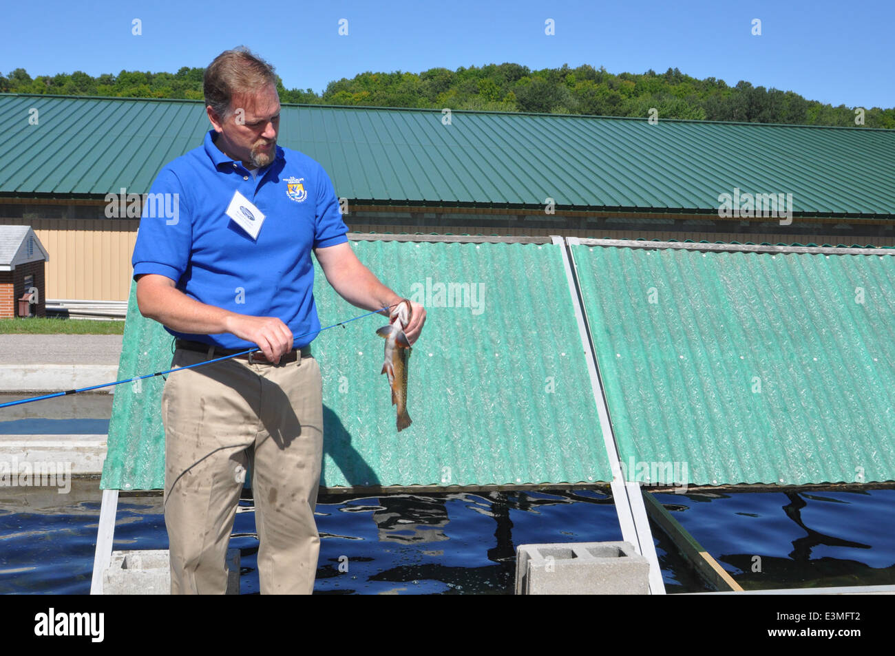 Roger Gordon, fish hatchery manager, engages children by showing a live ...