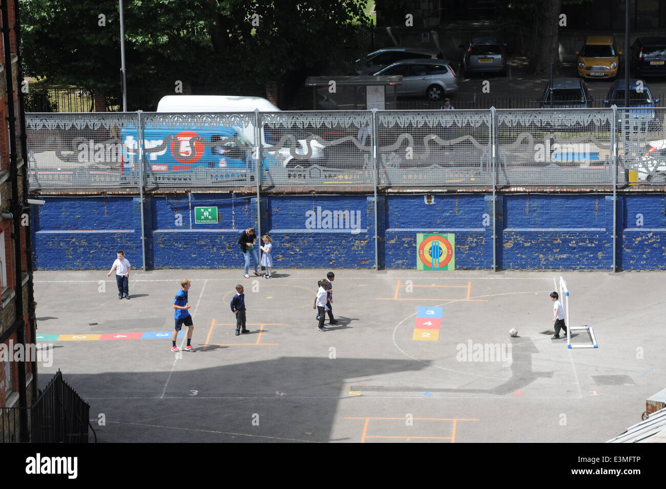 School children playing in a school playground in an inner city london ...