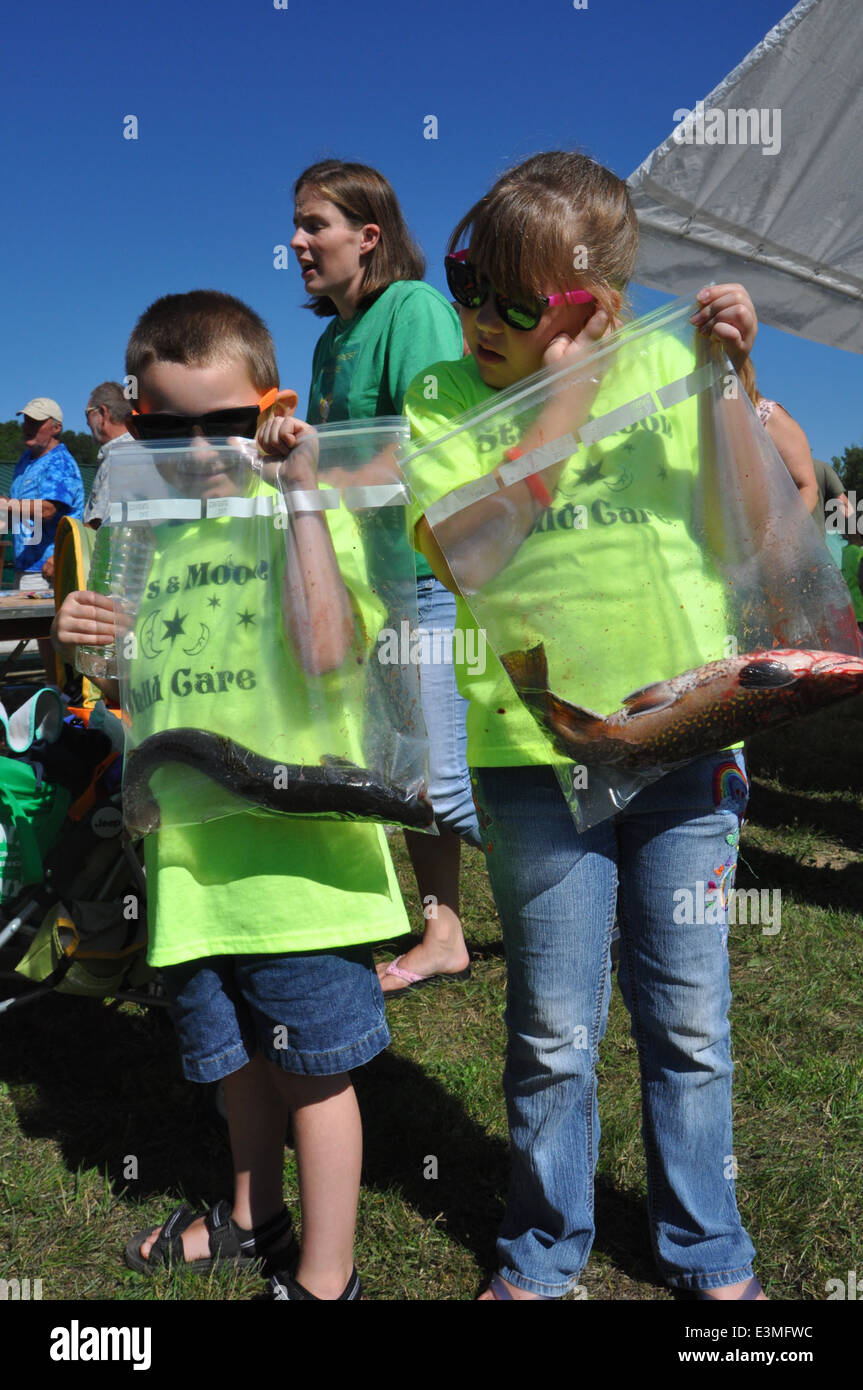 This image features individuals proudly displaying their catch ...
