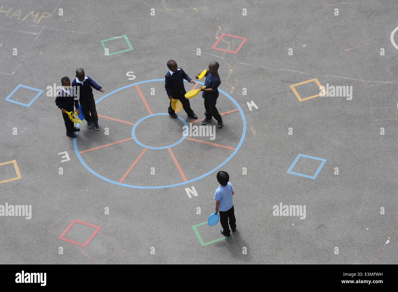 School children playing in a school playground in an inner city london ...
