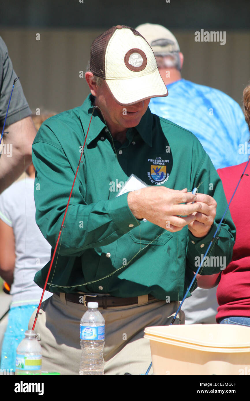 A U.S. Fish and Wildlife Service (USFWS) photograph of staff cutting ...