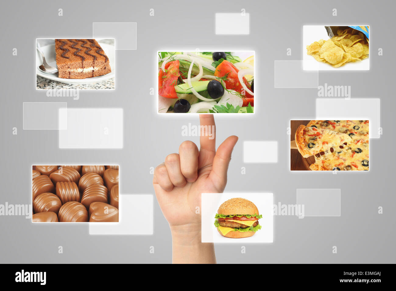 Woman hand uses touch screen interface with food on grey backround ...