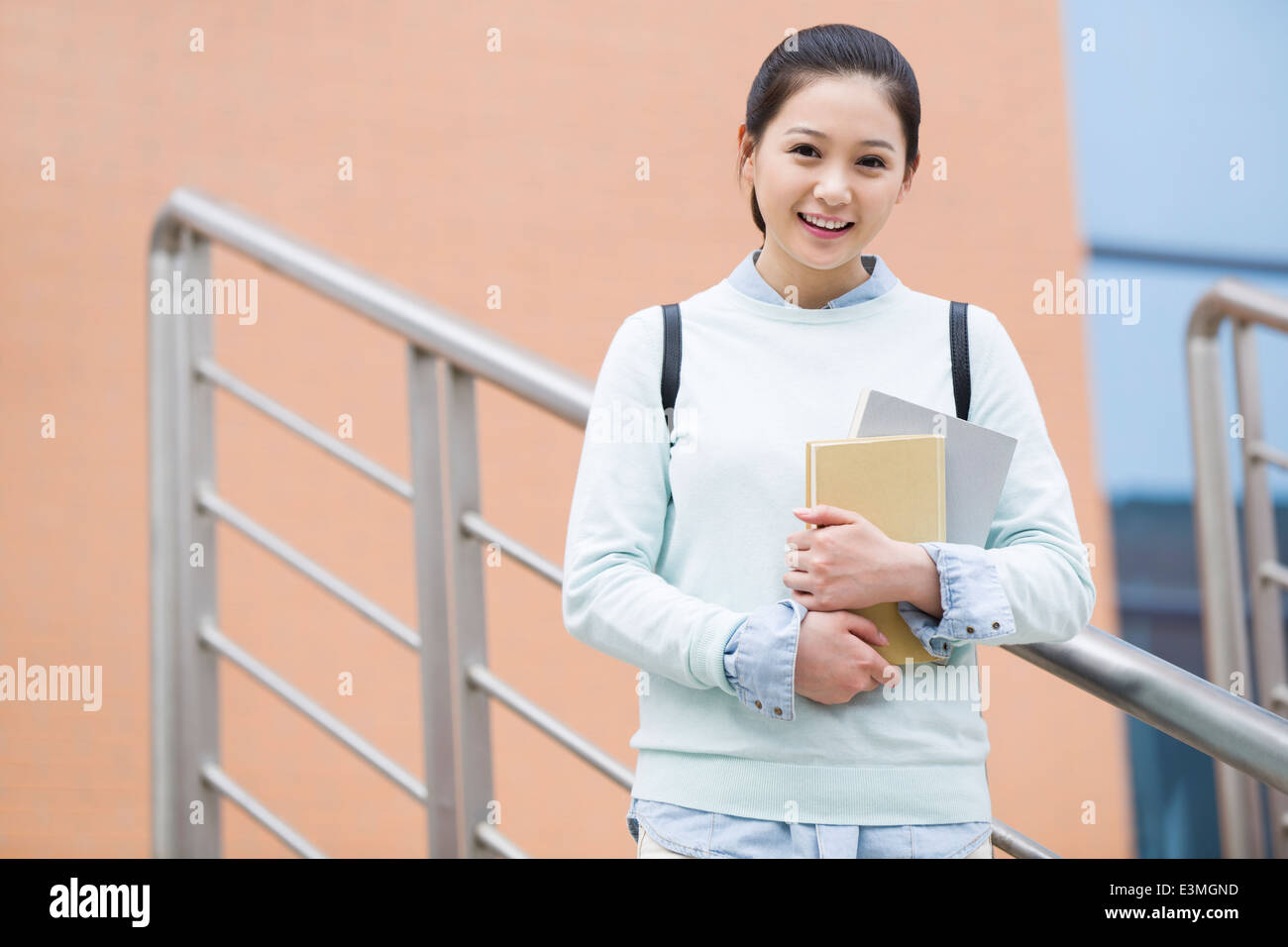 Female college student outside library Stock Photo - Alamy