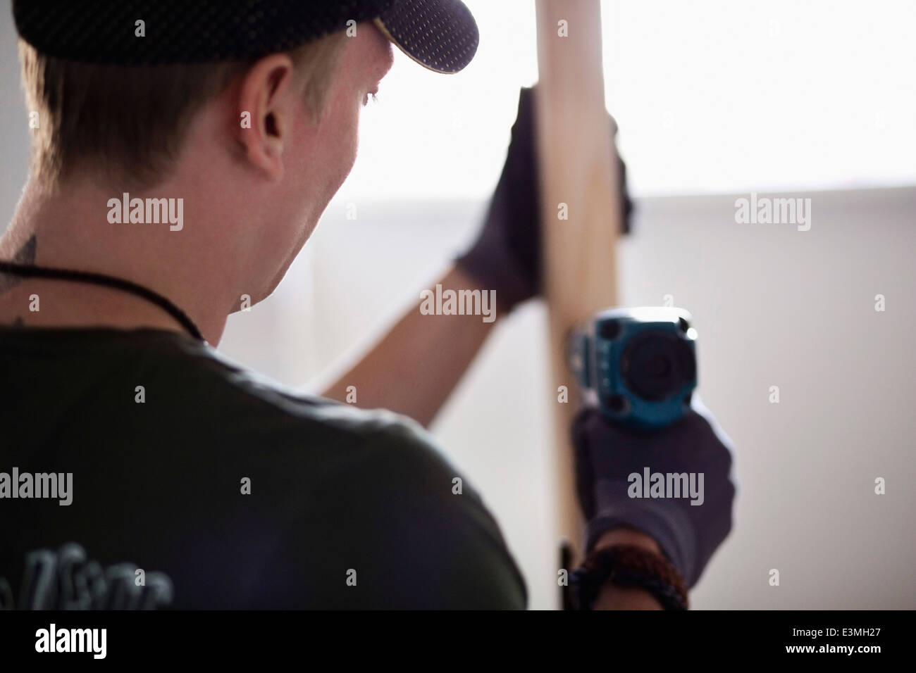 Rear view of carpenter working at site Stock Photo - Alamy