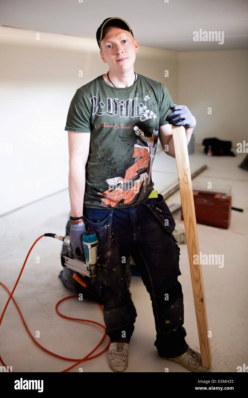 Full length portrait of confident carpenter standing at site Stock ...