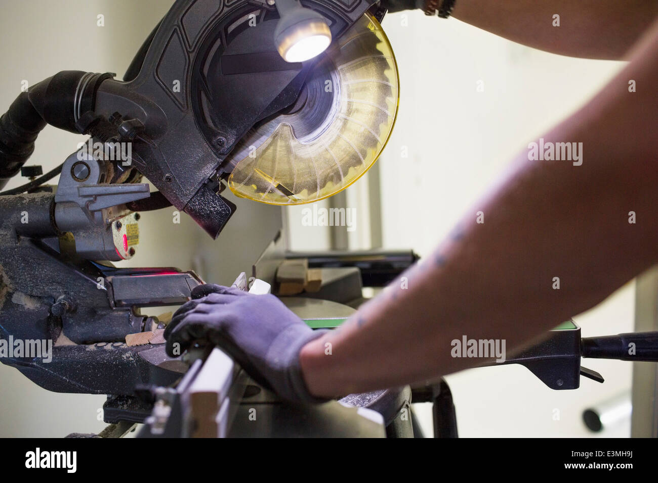 Construction worker using electric saw at site Stock Photo - Alamy