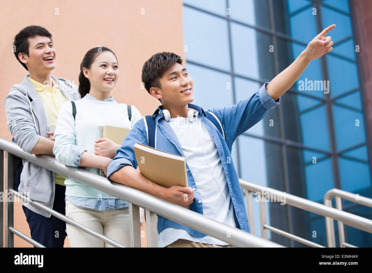 Young college students outside library Stock Photo - Alamy