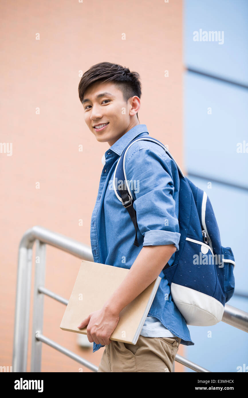 Male college student outside library Stock Photo - Alamy