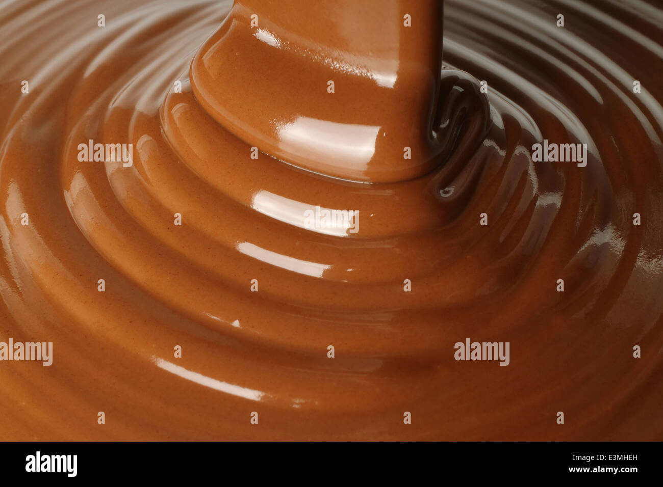 Milk chocolate flow close-up texture Stock Photo - Alamy