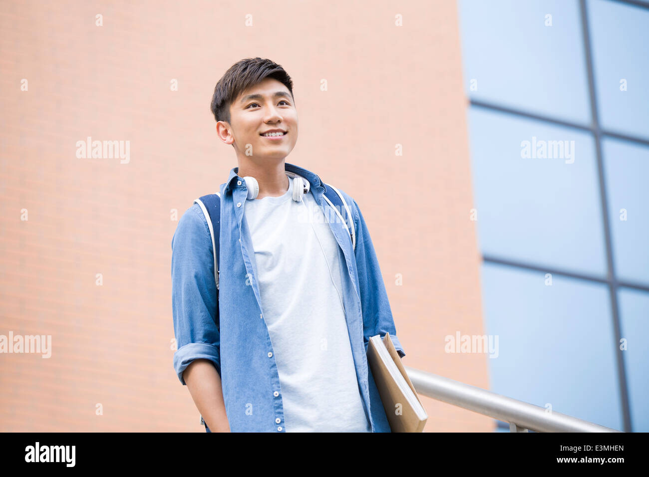 Male college student outside library Stock Photo - Alamy