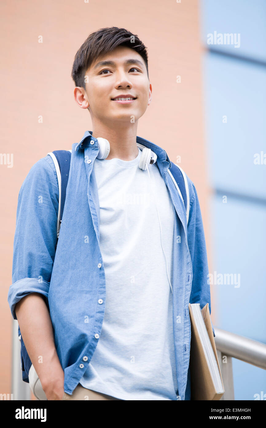Male college student outside library Stock Photo - Alamy
