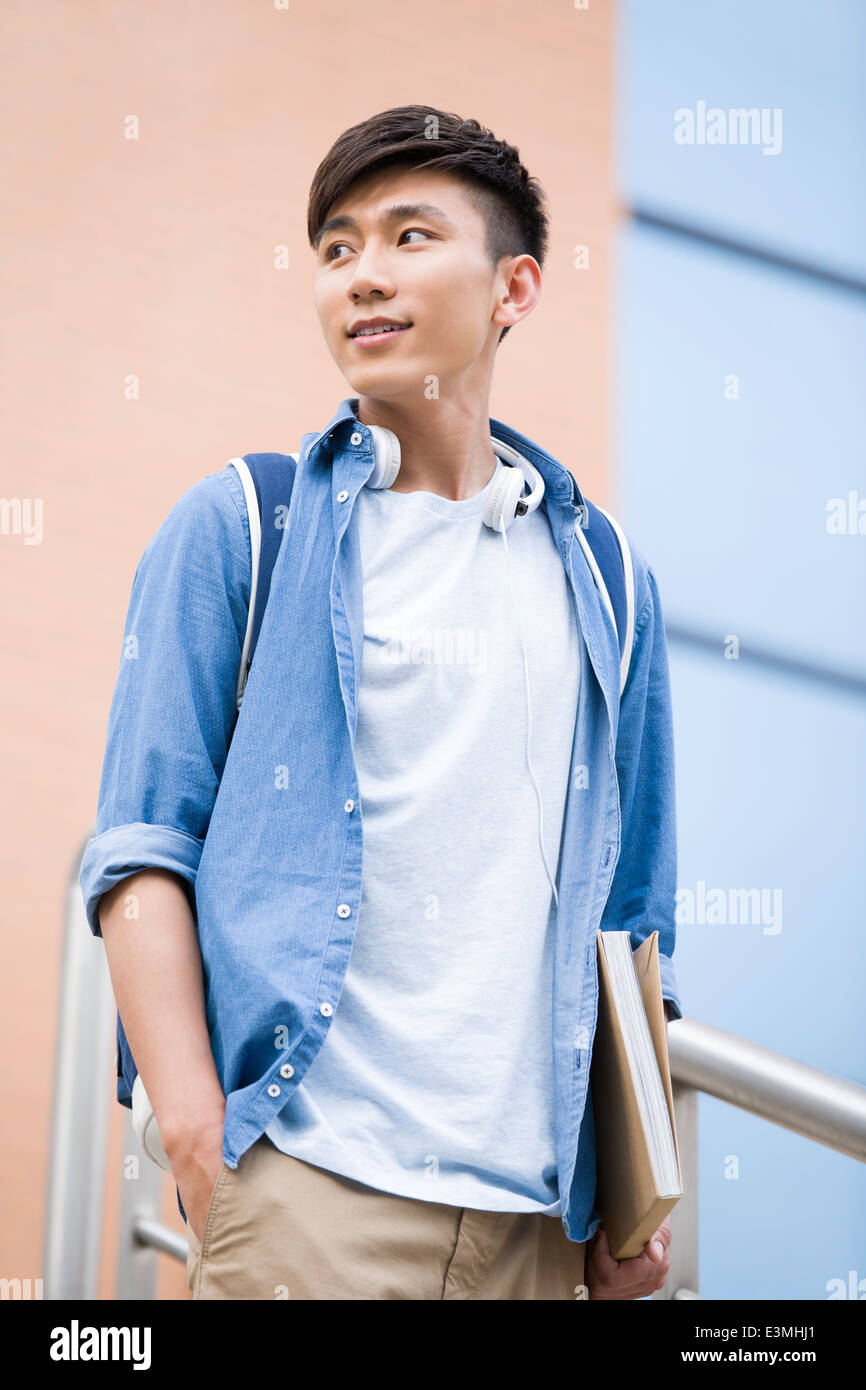 Male college student outside library Stock Photo - Alamy