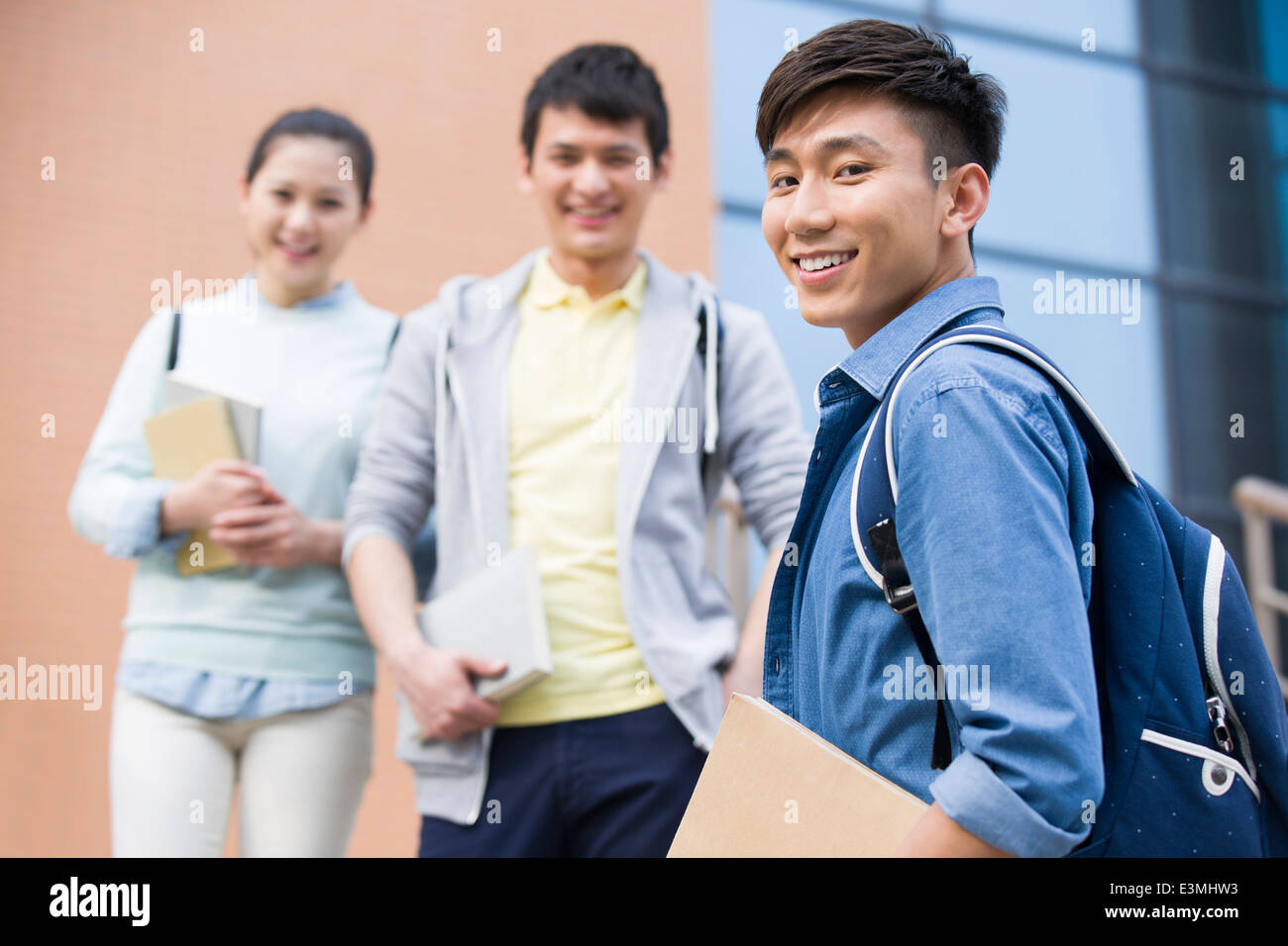 Young college students outside library Stock Photo - Alamy