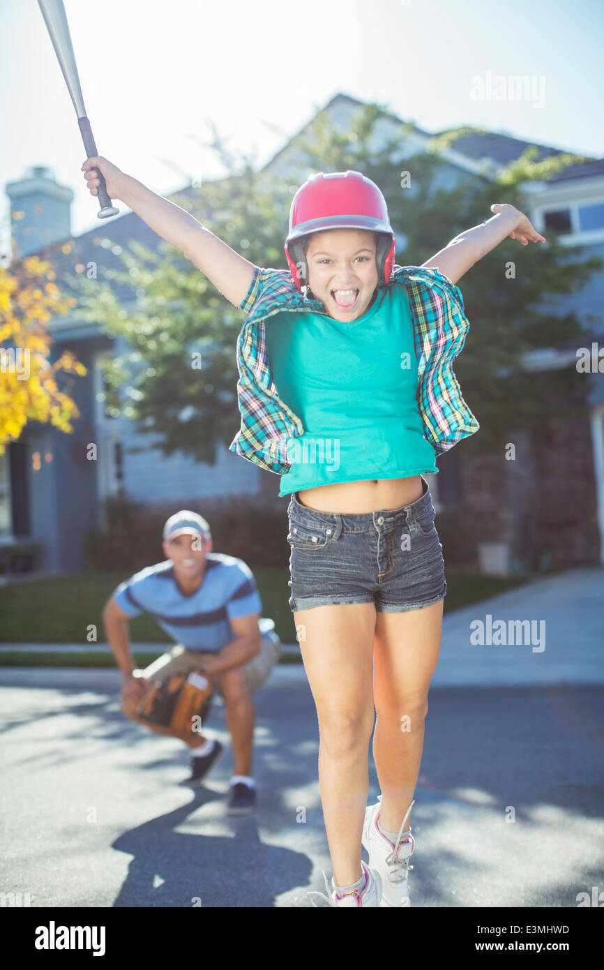 Portrait of cheering girl playing baseball in street Stock Photo - Alamy