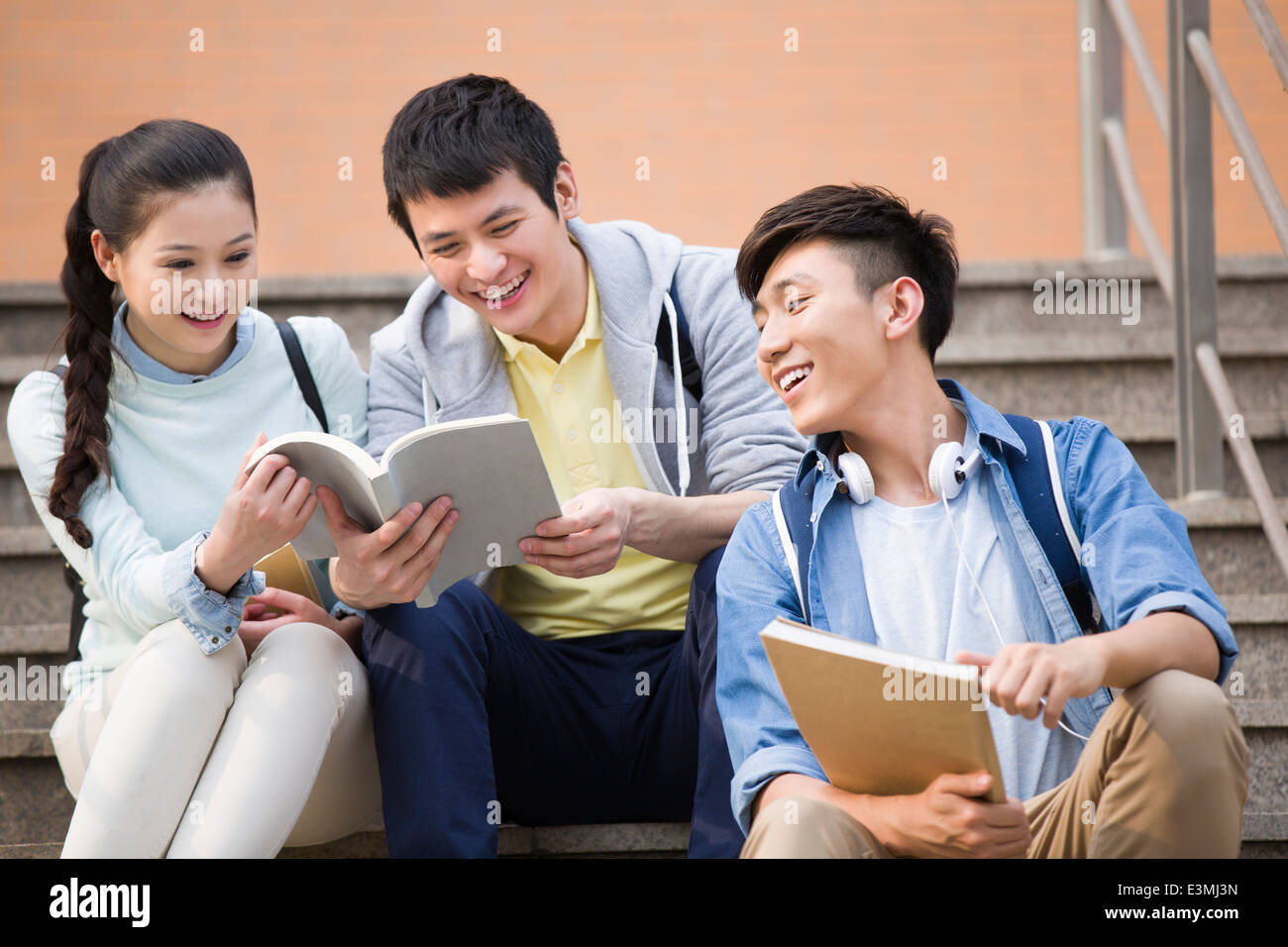 Young college students reading outside library Stock Photo - Alamy