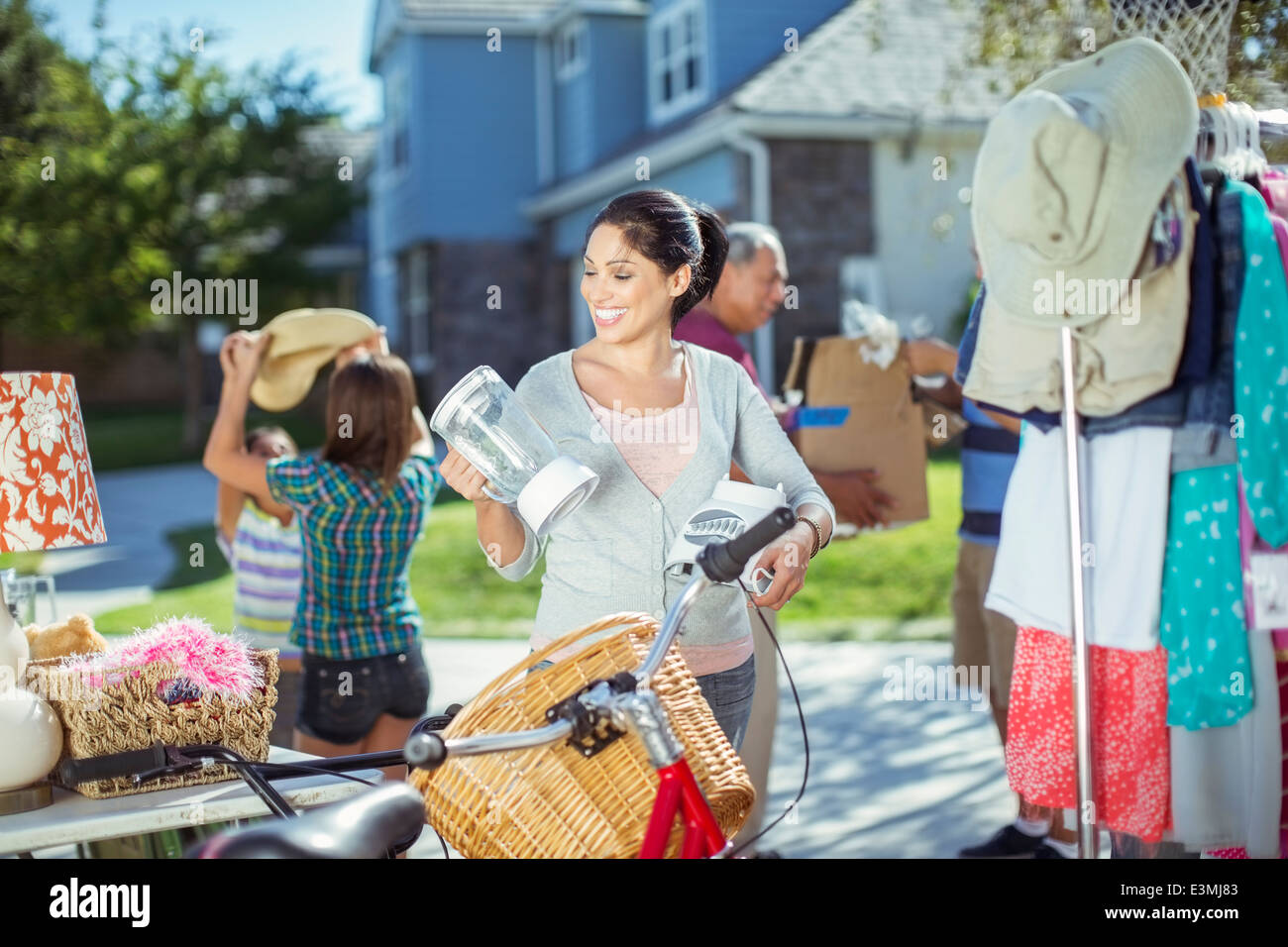 Woman shopping at yard sale Stock Photo - Alamy