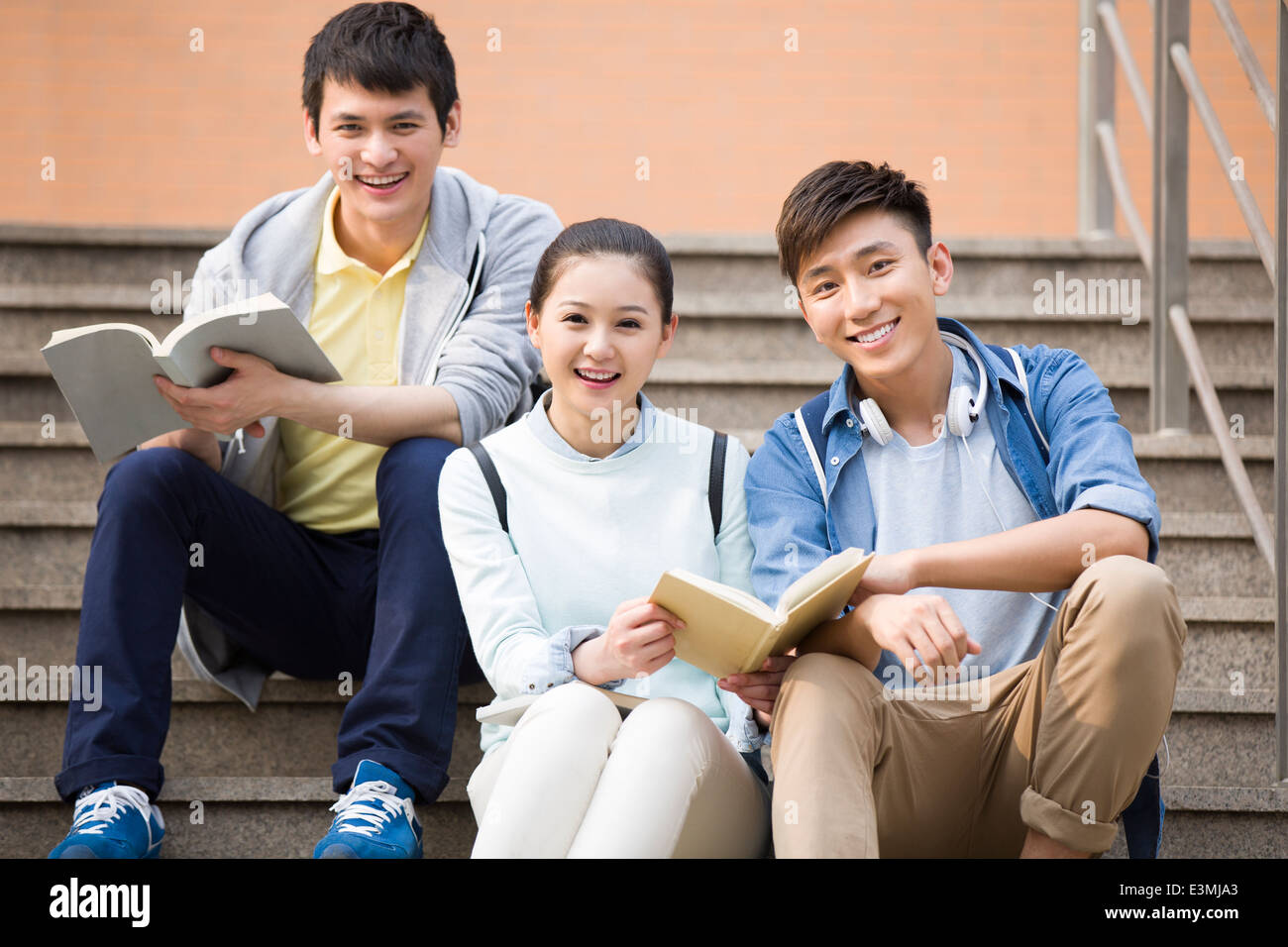 Young college students reading outside library Stock Photo - Alamy