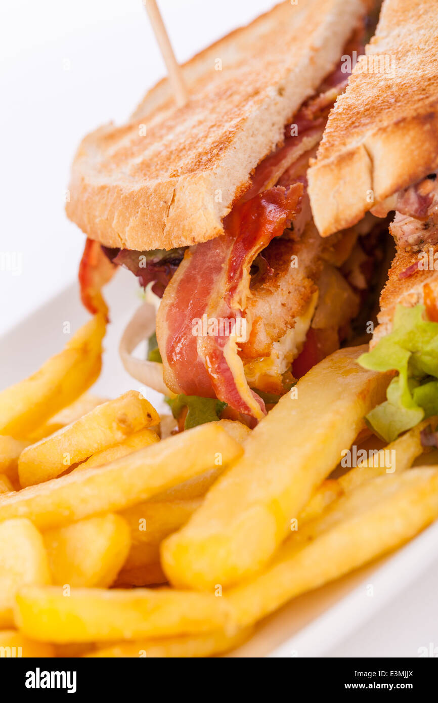 Club sandwich on toasted white bread with a meat filling served with ...