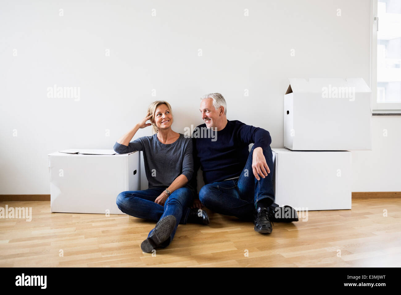 Mature couple relaxing after moving into their new house Stock Photo ...