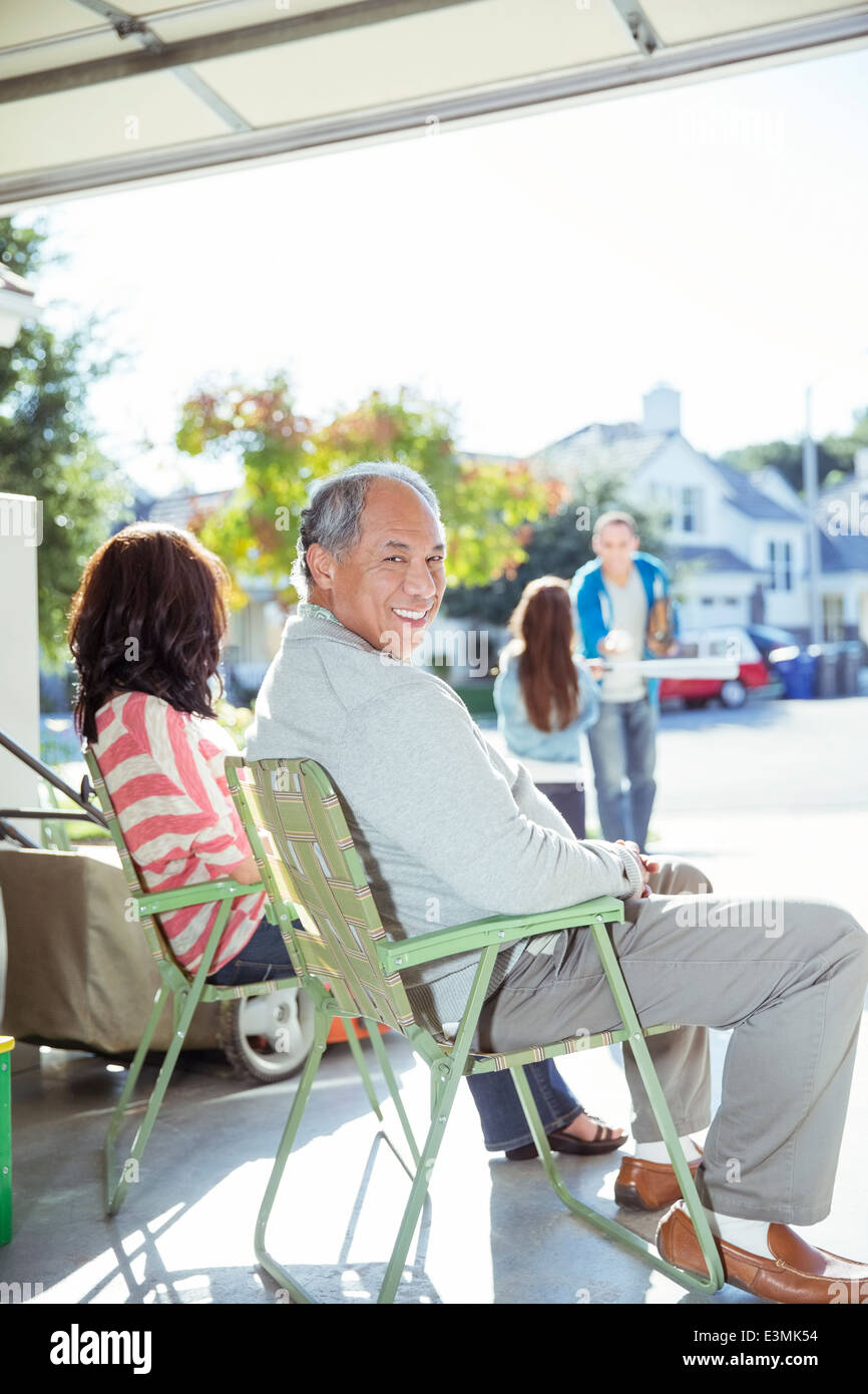 Portrait of smiling man in garage Stock Photo - Alamy