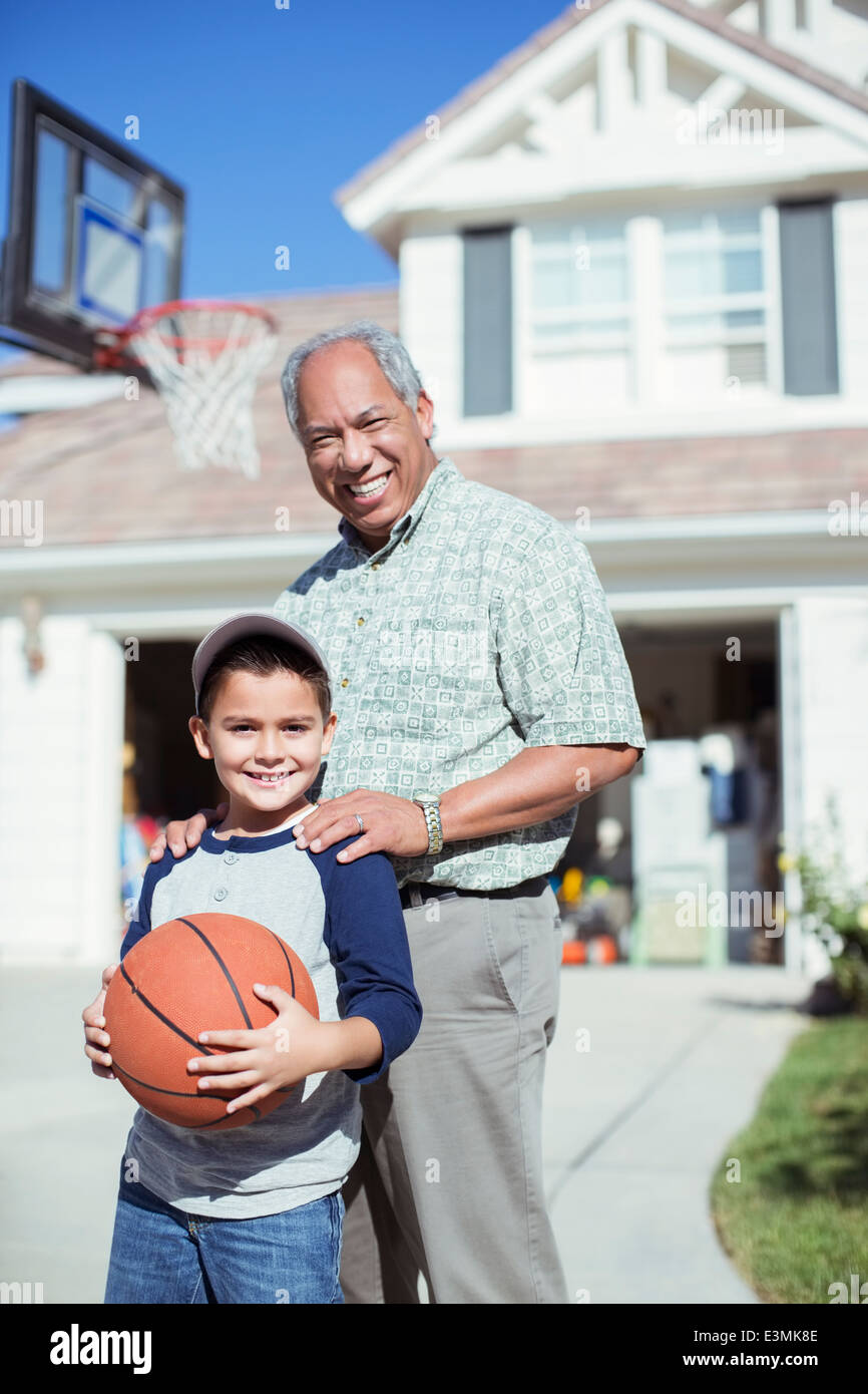 Portrait of smiling grandfather and grandson in sunny driveway Stock ...