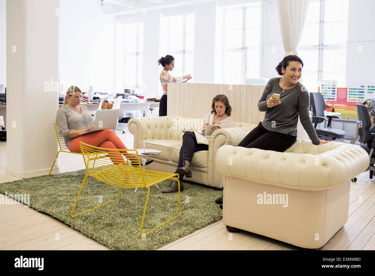 Creative businesswomen doing various activities in office Stock Photo ...