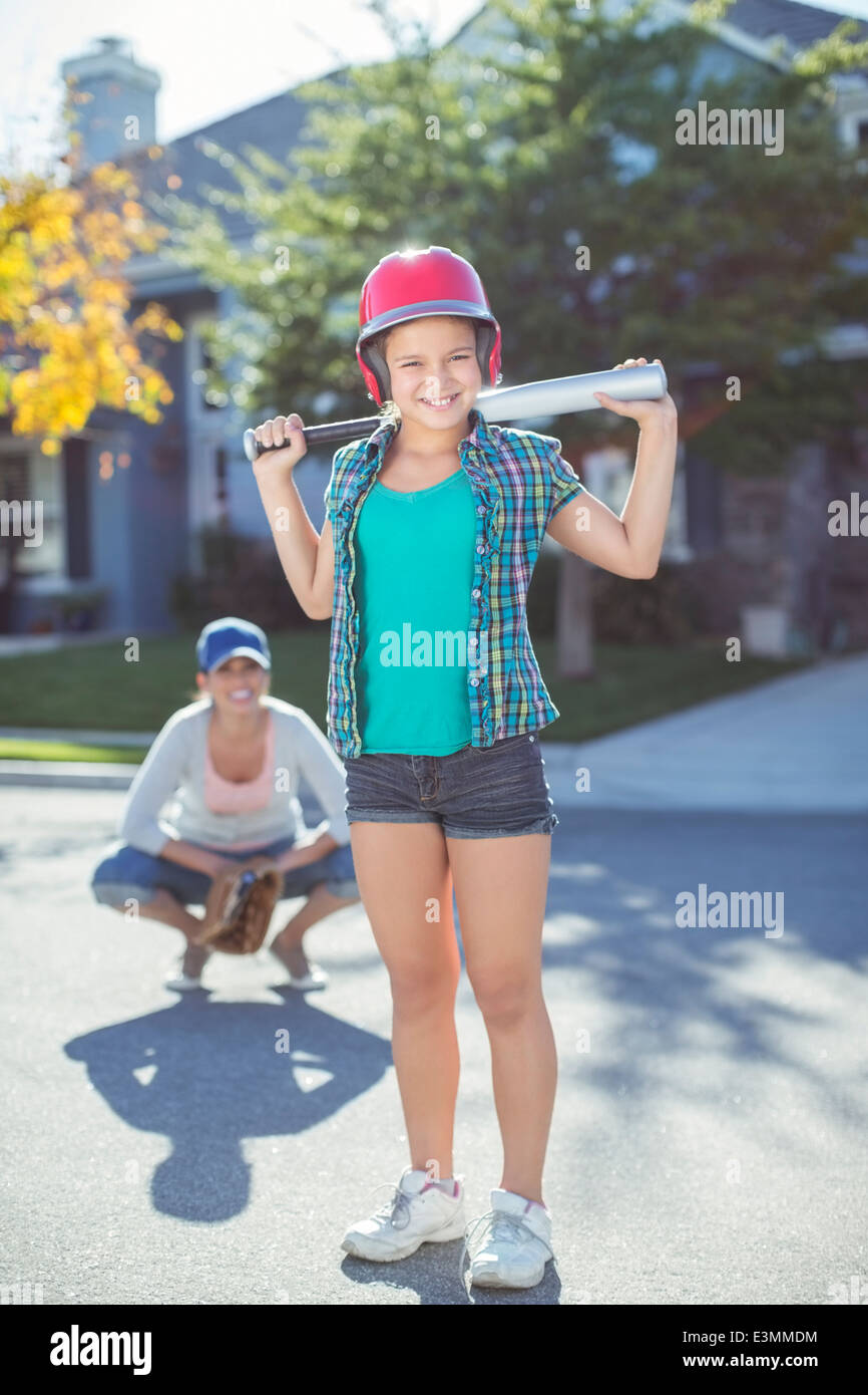 Portrait of smiling mother and daughter playing baseball Stock Photo ...