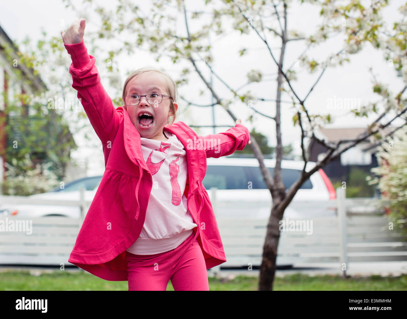 Excited girl with arms outstretched enjoying in lawn Stock Photo - Alamy