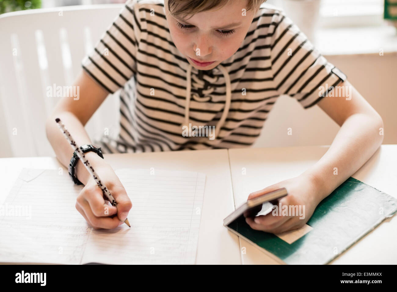 Boy using cellphone homework hi-res stock photography and images - Alamy