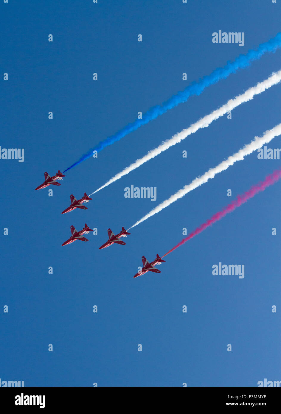 The Red Arrows jet planes British RAF aerobatic display team with colourful smoke and blue sky ...