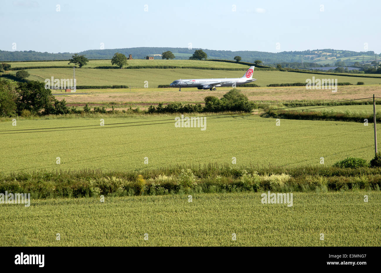 Exeter Airport Devon England UK viewed across farmland a A321 Airbus ...