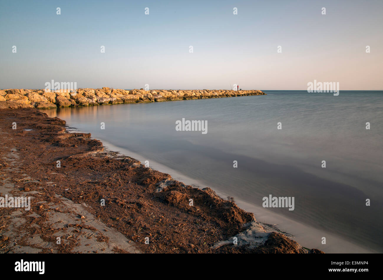 Man fishing on jetty Stock Photo - Alamy
